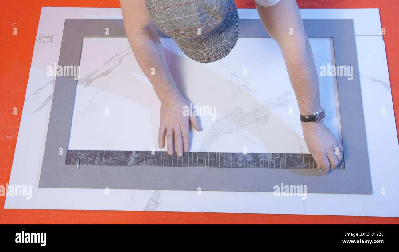 Worker connects tile pattern. Creative. Man connects details of square ...