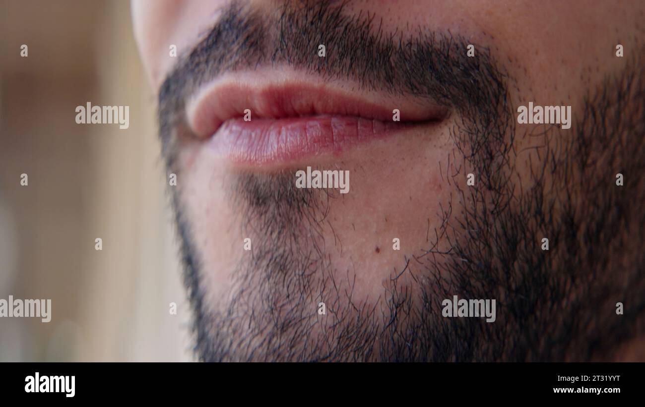 Portrait of a man. Action. A young man with stubble who was shot from a ...