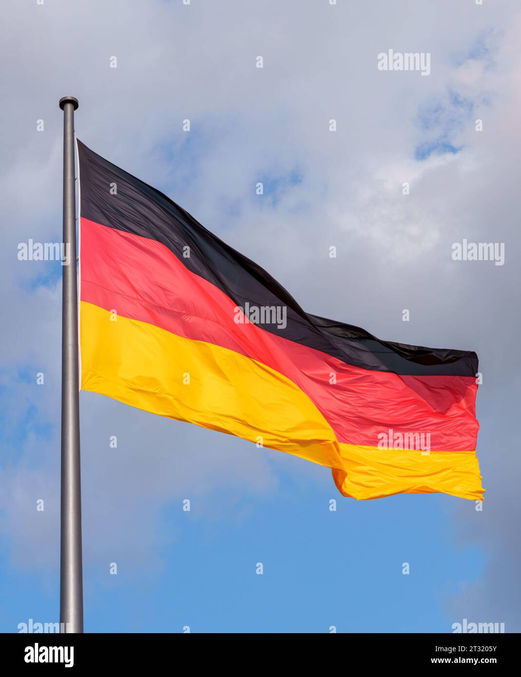The German flag flying from a flagpole flapping in the wind, Germany ...