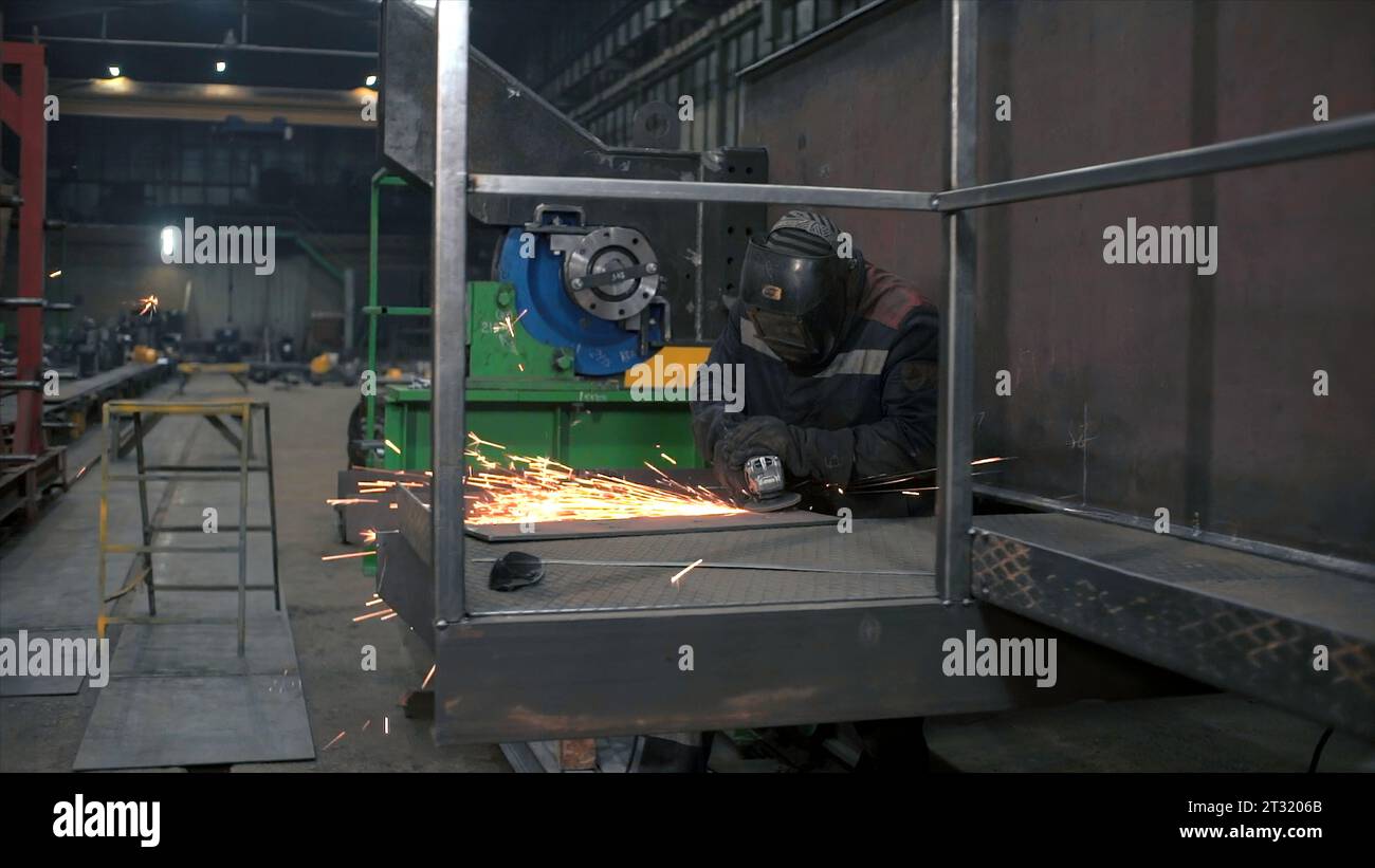 Welder grinds plate by welding. Clip. Welder grinds iron plate with ...