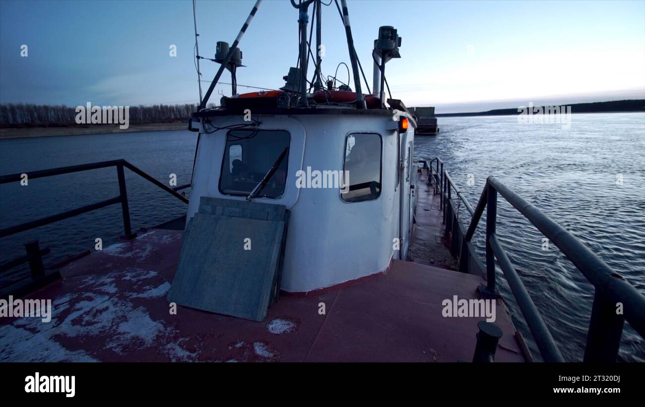 Barge in tow of fishing boat. Clip. Boat carries barge with cargo in ...