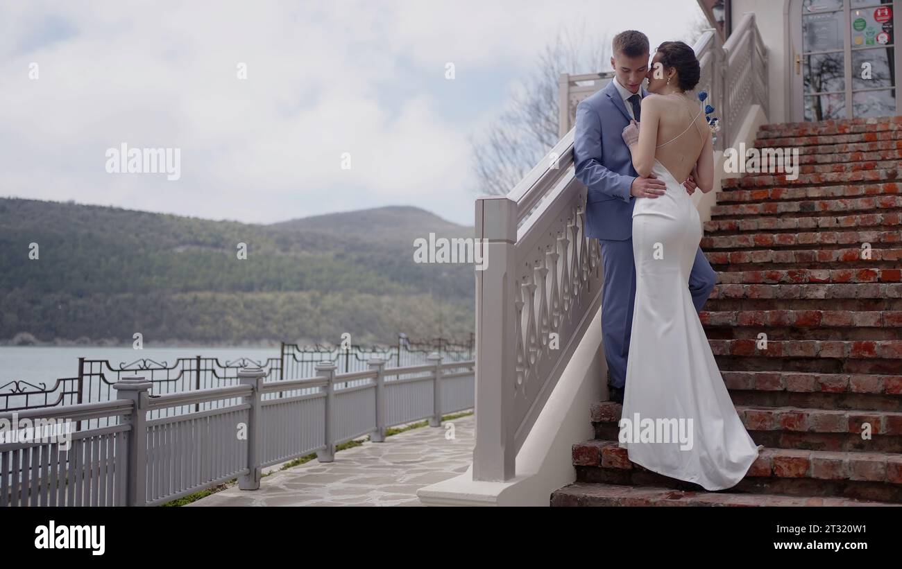 A young married couple. Action. Beautiful newlyweds posing in the park ...
