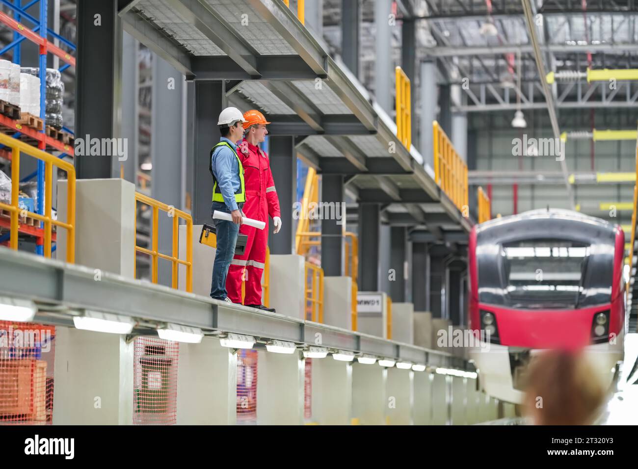 Teacher talking to apprentices at railway engineering facility Stock ...
