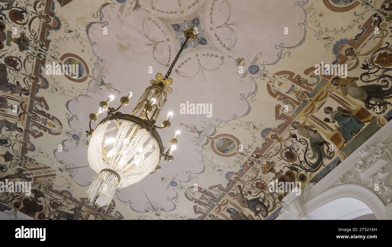 Large ceiling with glass chandelier. Action. A painted ceiling with a ...