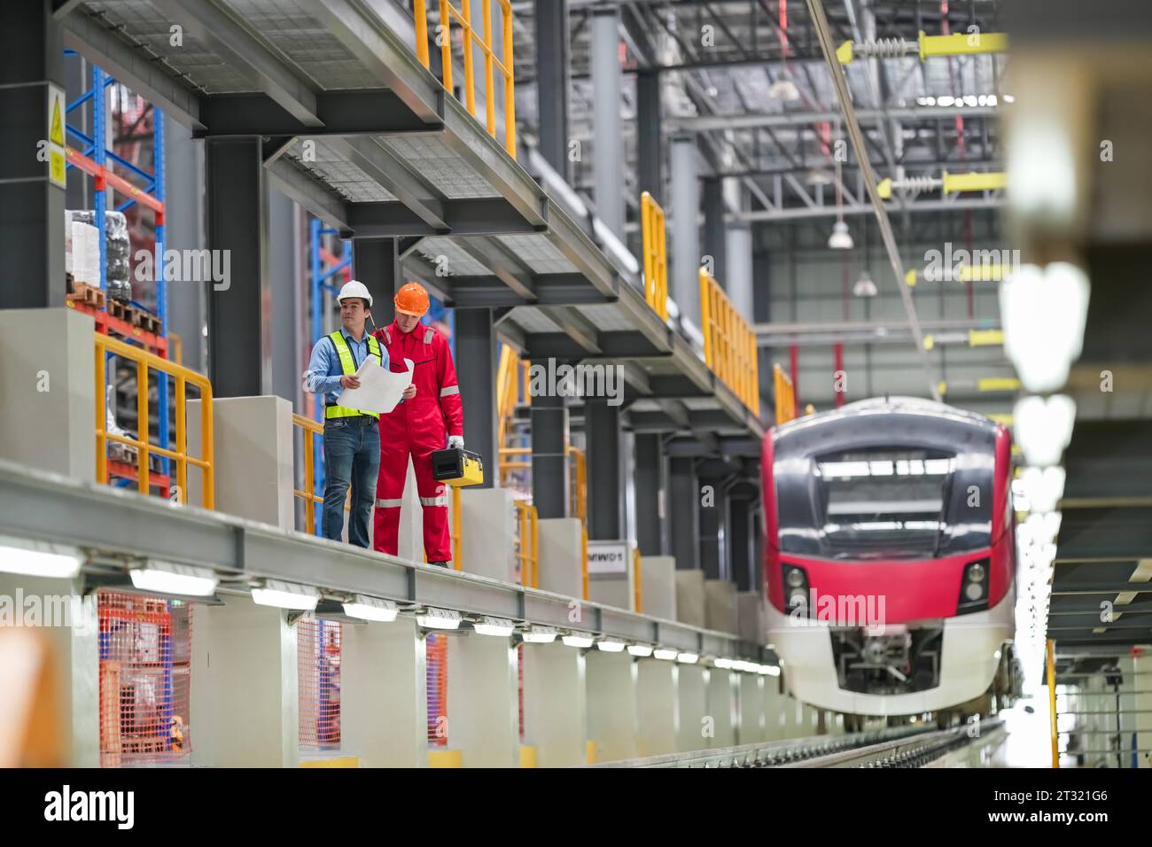 Teacher talking to apprentices at railway engineering facility Stock ...