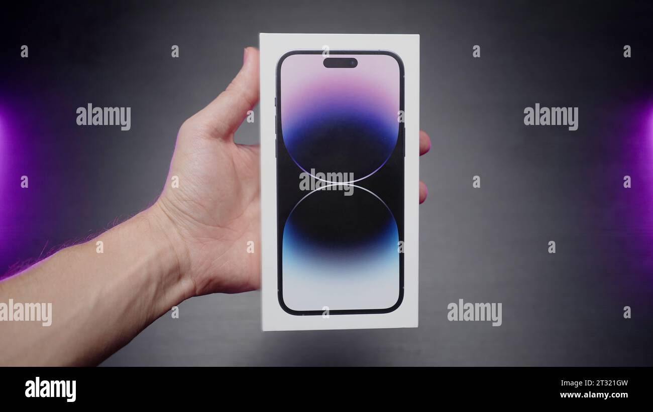 New iPhone 14. Action. Buying a packed black phone that is held in your ...