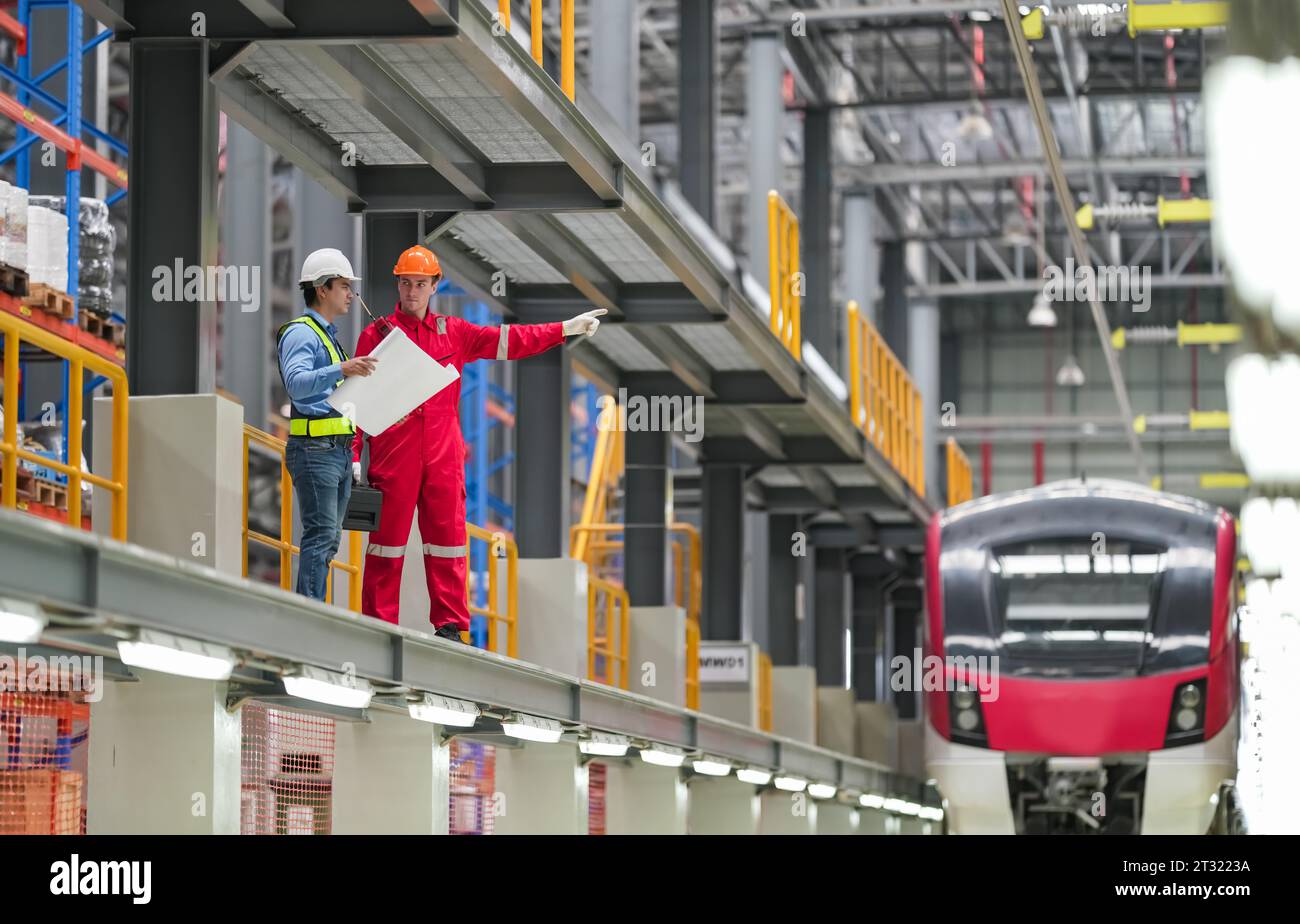 Teacher talking to apprentices at railway engineering facility Stock ...