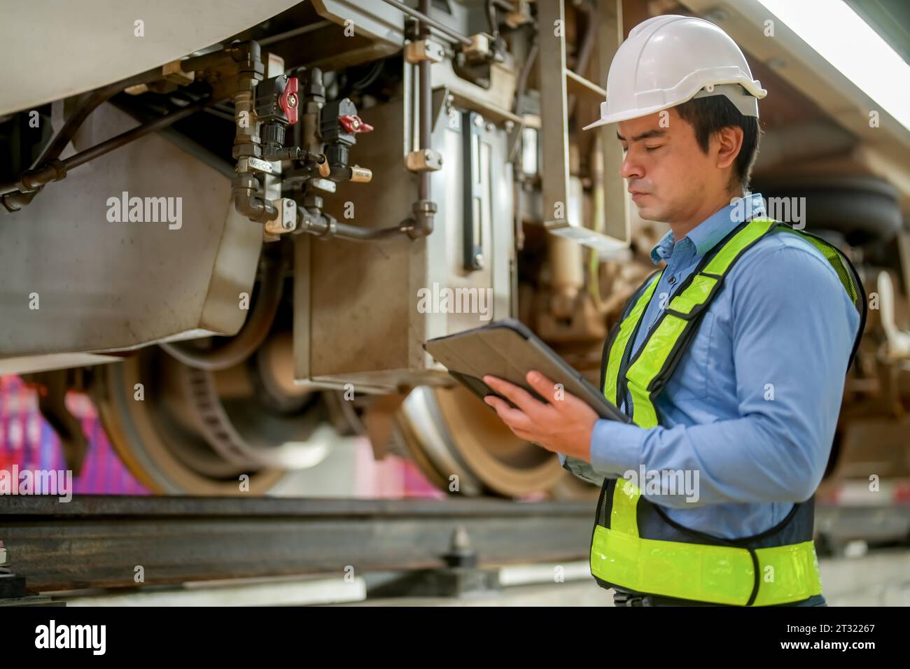 Engineer inspecting sky train in the maintenance plant Stock Photo - Alamy