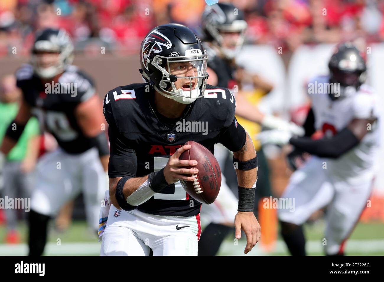 Atlanta Falcons quarterback Desmond Ridder (9) runs out of the pocket ...