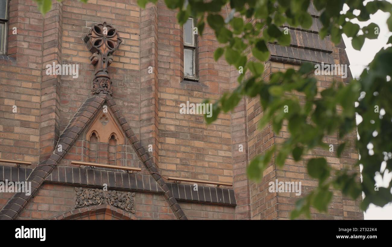 Branches of green tree on background of ancient church. Action. Stone ...