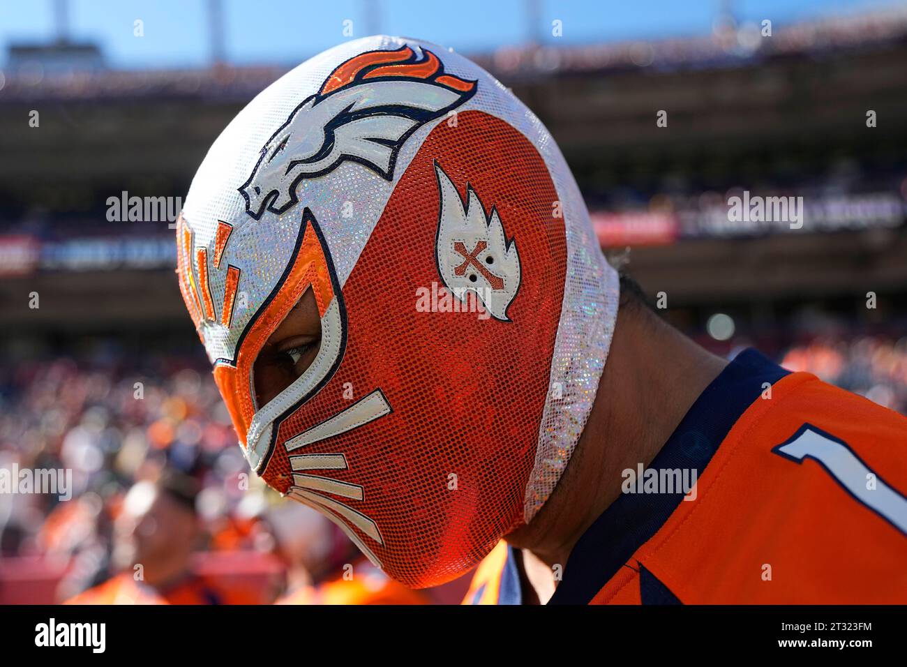 A fan wears a lucha libre mask before an NFL football game between the ...