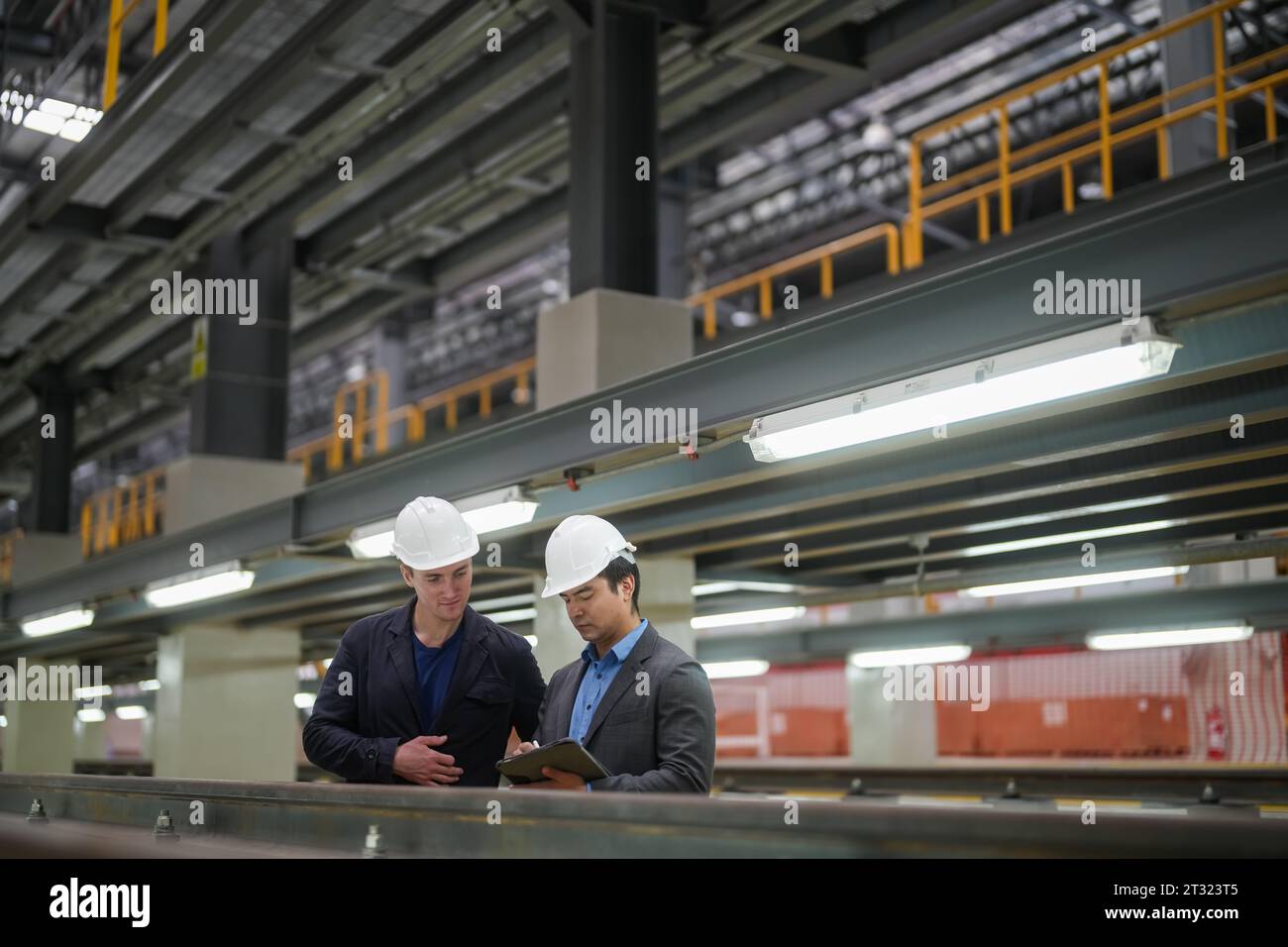 Teacher talking to apprentices at railway engineering facility Stock ...