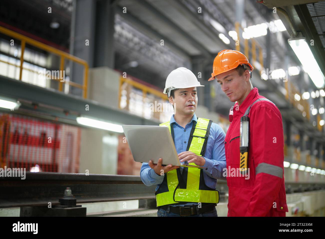 Teacher talking to apprentices at railway engineering facility Stock ...