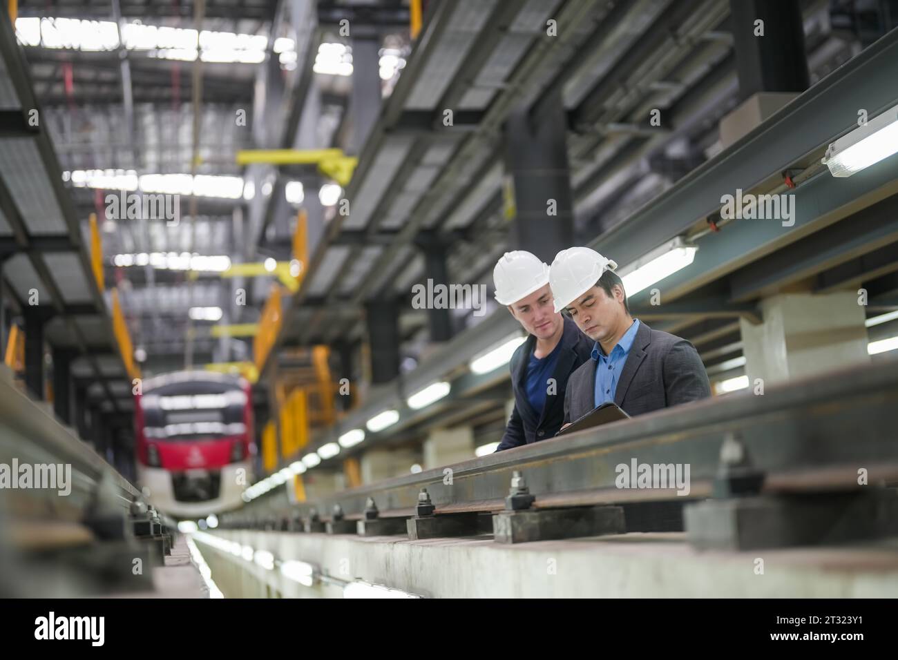 Teacher talking to apprentices at railway engineering facility Stock ...