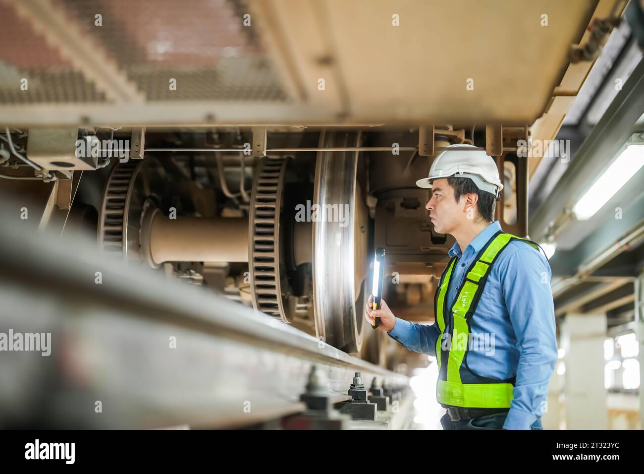 Engineer inspecting sky train in the maintenance plant Stock Photo - Alamy
