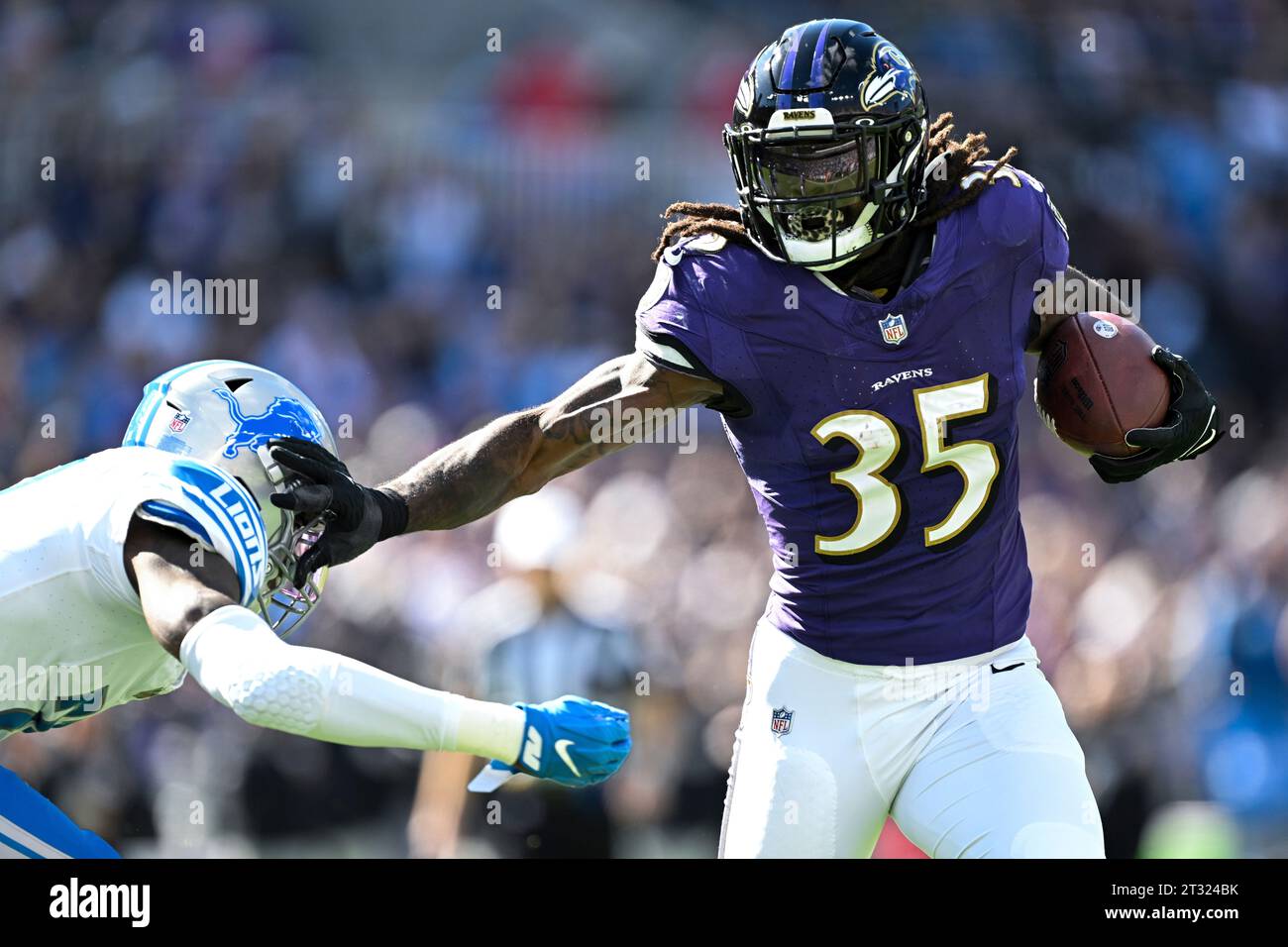 Baltimore Ravens running back Gus Edwards (35) stiff arms Detroit Lions ...