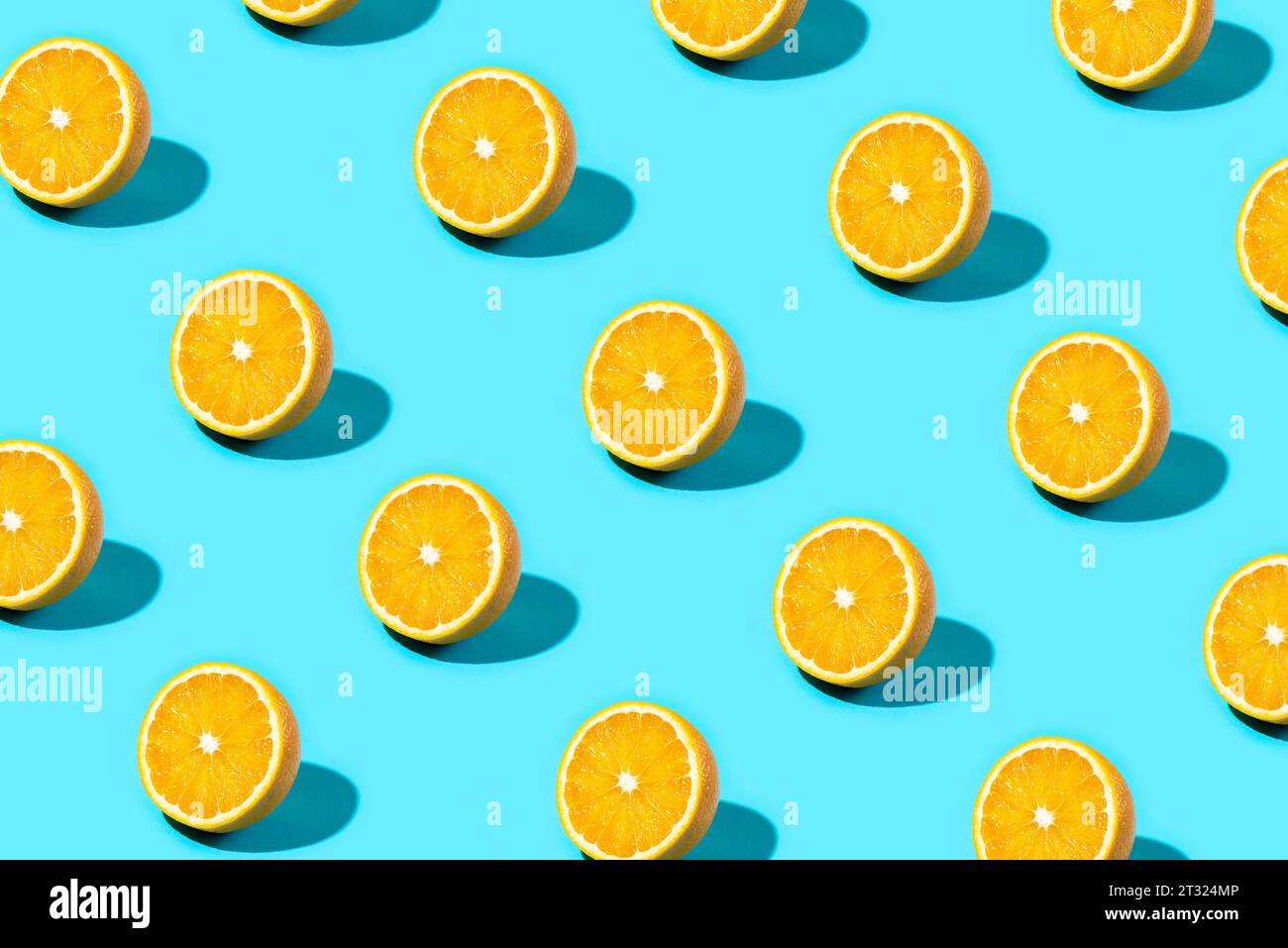 Trendy Summer food pattern made with orange slice on bright light blue ...