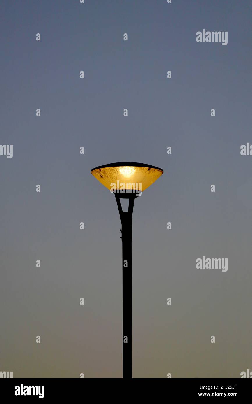 Street lights in the park at dusk with lights on Stock Photo - Alamy
