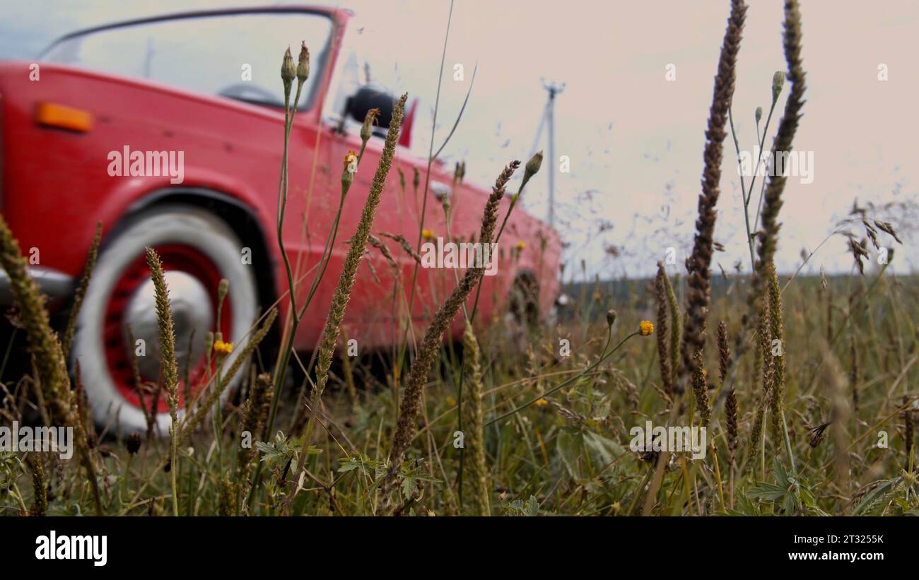 Russian village car. Stock. A red old car that drives through deep pits ...