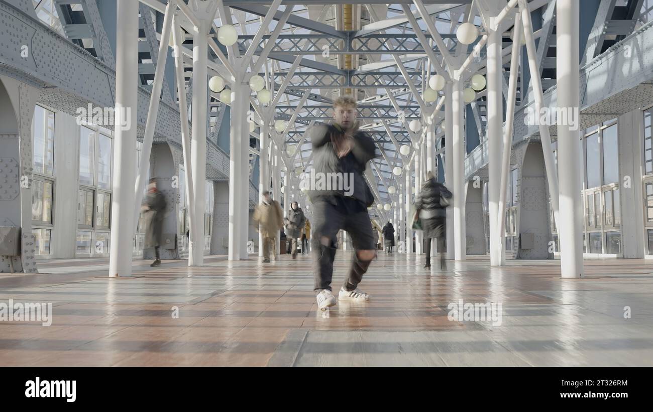 Young man dancing in city. Action. Modern dancer moves in crowd of ...