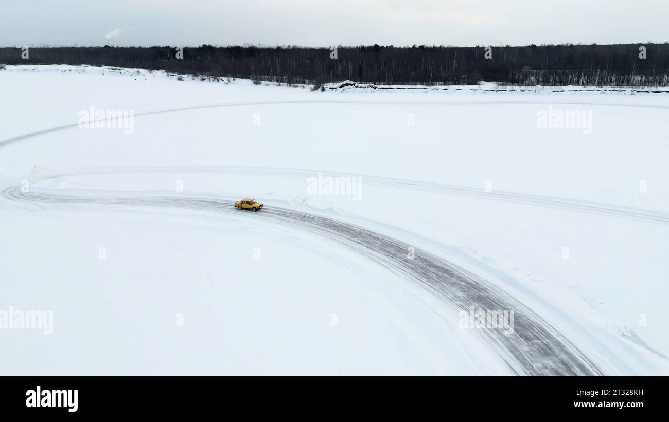 Aerial view of a race car moving fast through the snow desert. Clip ...