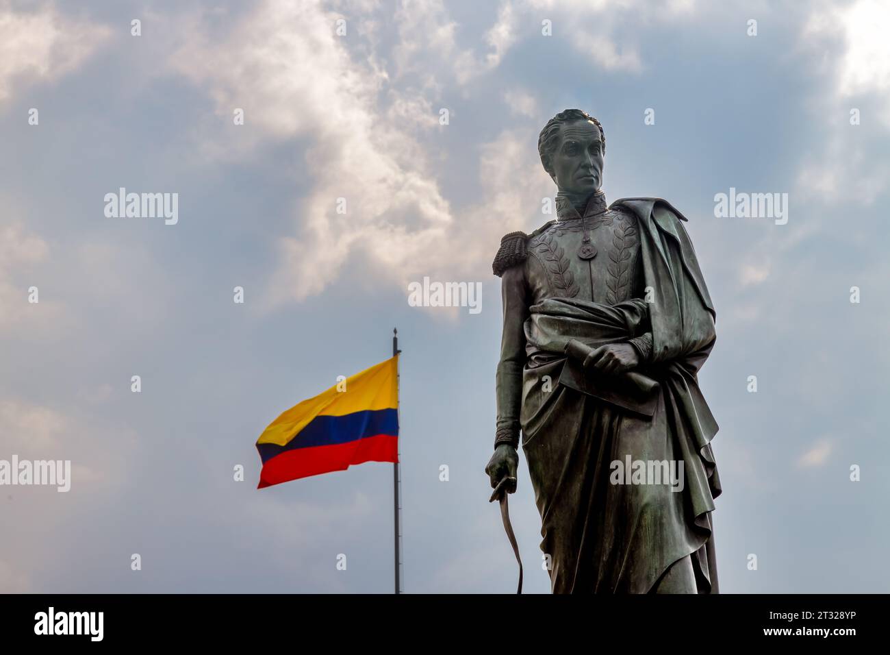 Simon Bolivar statue with Colombian flag behind in the main square of ...