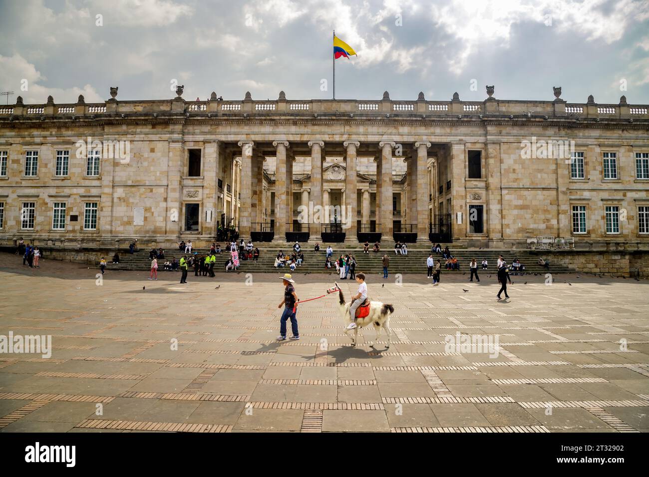 Bogota, Colombia - January 1, 2023: Man rides a child on a llama ...