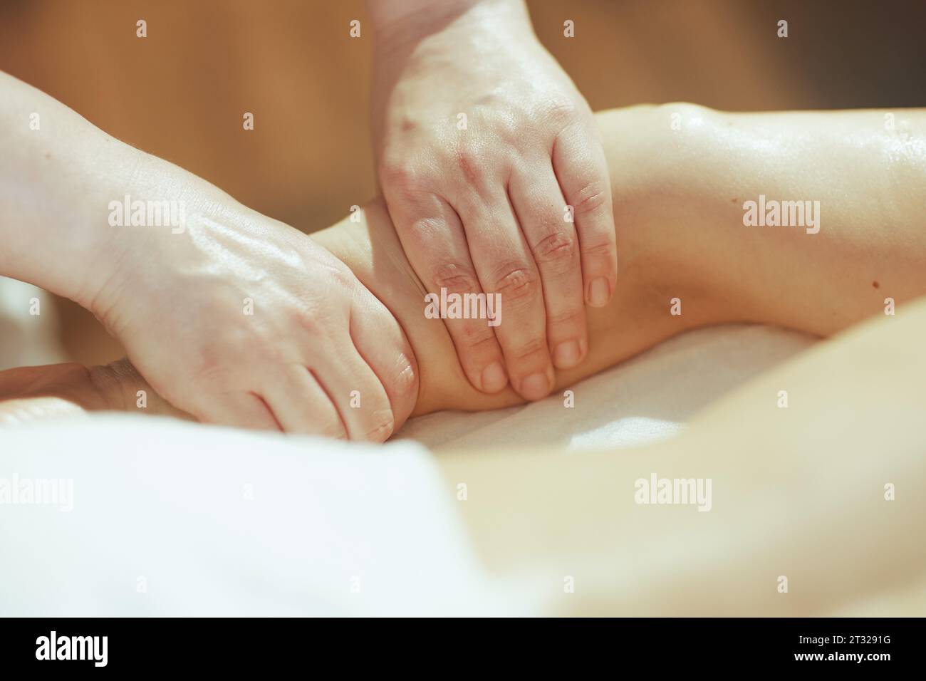 Healthcare time. Closeup on medical massage therapist in massage cabinet massaging clients arm ...