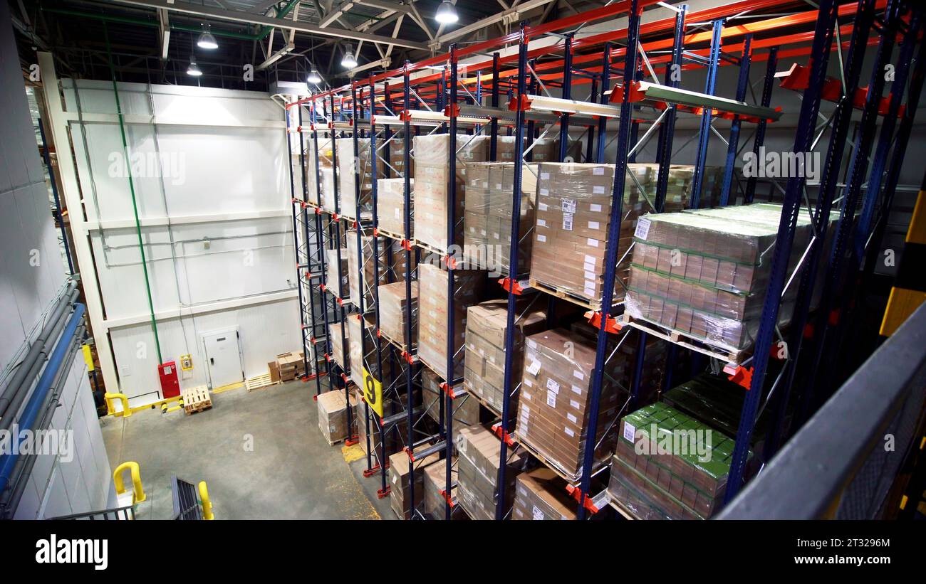 Boxes stored on high shelves at industrial warehouse. Creative ...