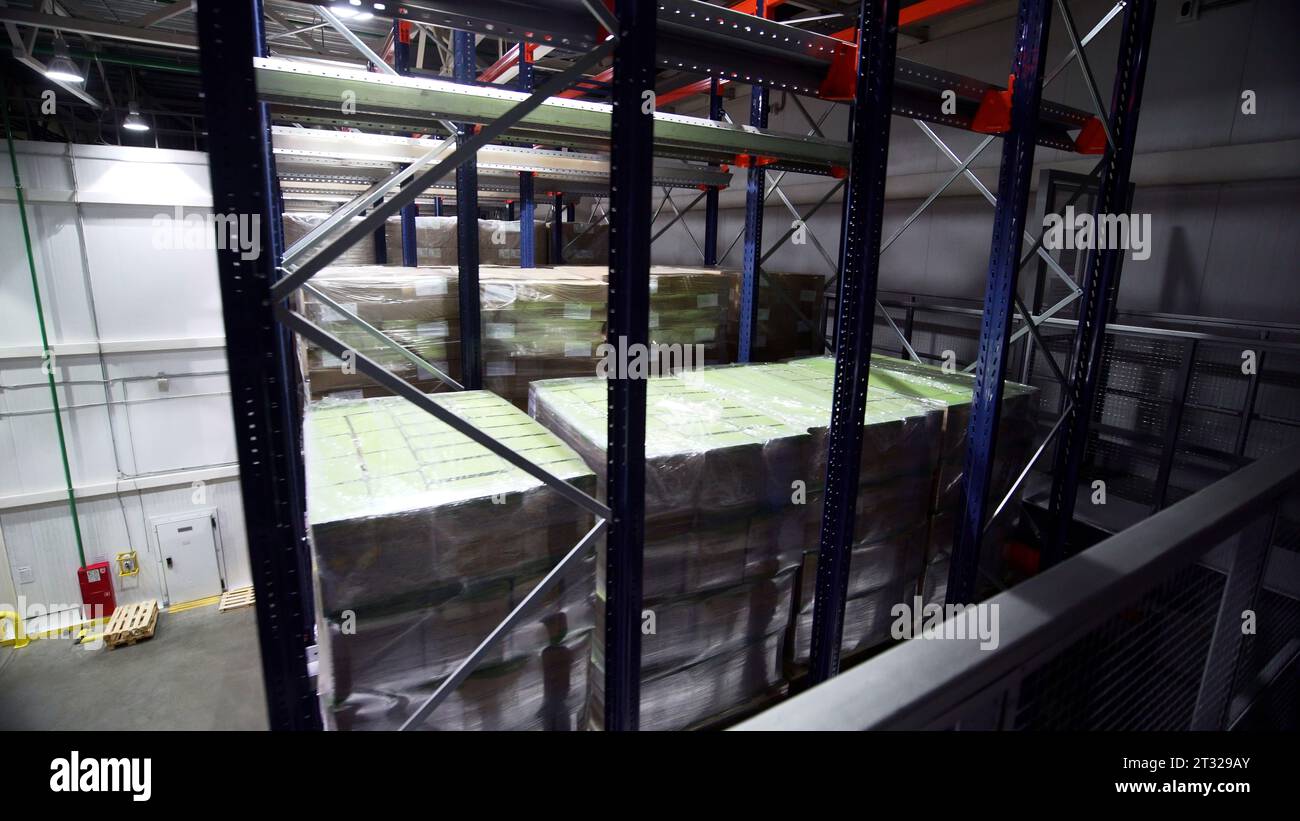 Boxes stored on high shelves at industrial warehouse. Creative ...