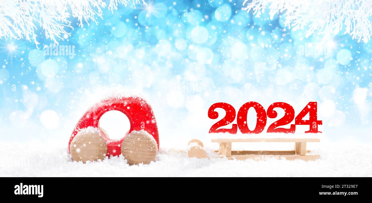 Red Wooden Car Pulling Sled with Wooden 2024 Numbers in perspective on ...