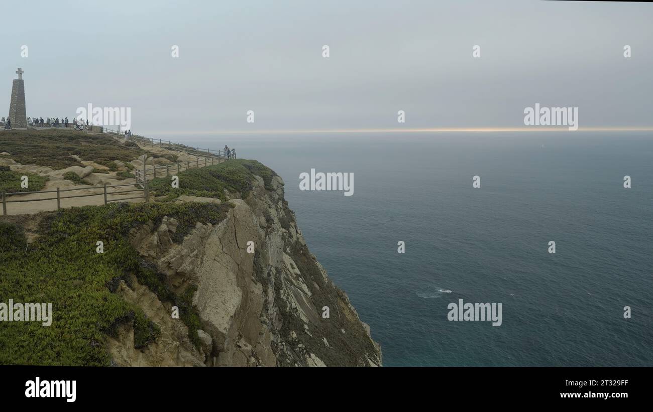 Aerial view of a cliff and calm sea water. Action. Stunning view of a ...