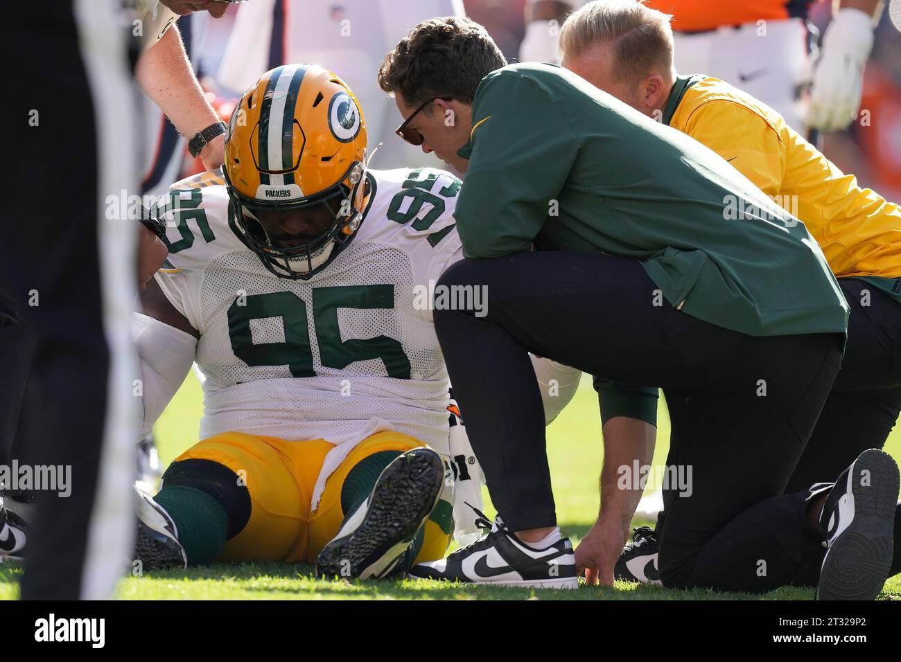 Green Bay Packers defensive tackle Devonte Wyatt (95) is tended to ...