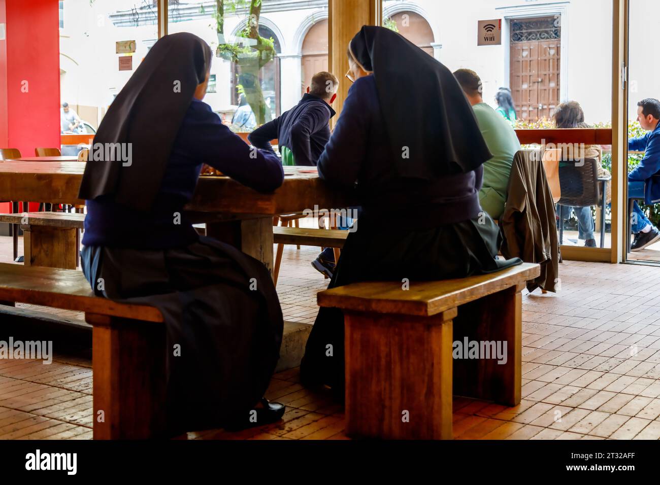 Bogota, Colombia - January 1, 2023: Two nuns chat at a table in a ...
