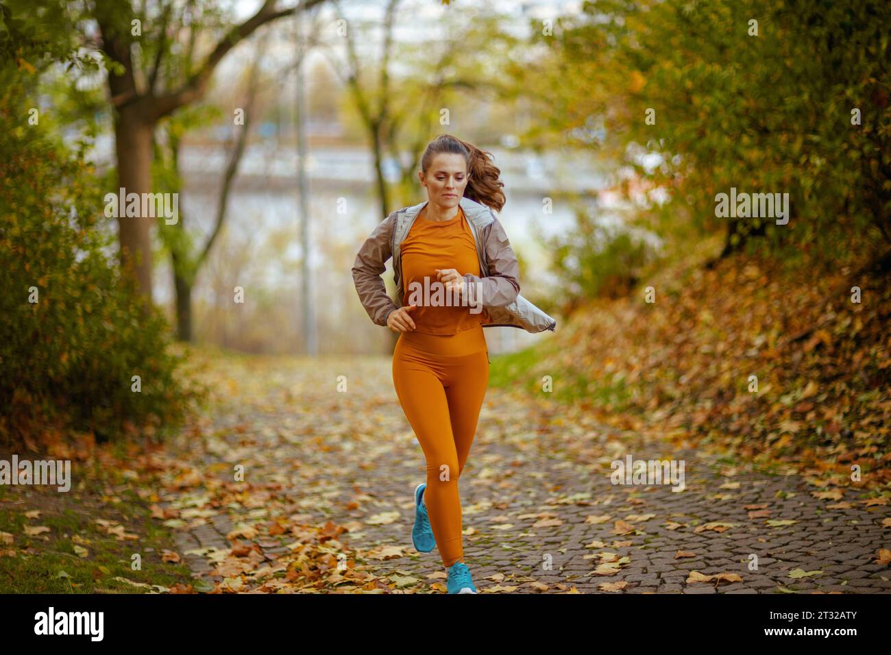 Hello autumn. Full length portrait of elegant woman in fitness clothes ...