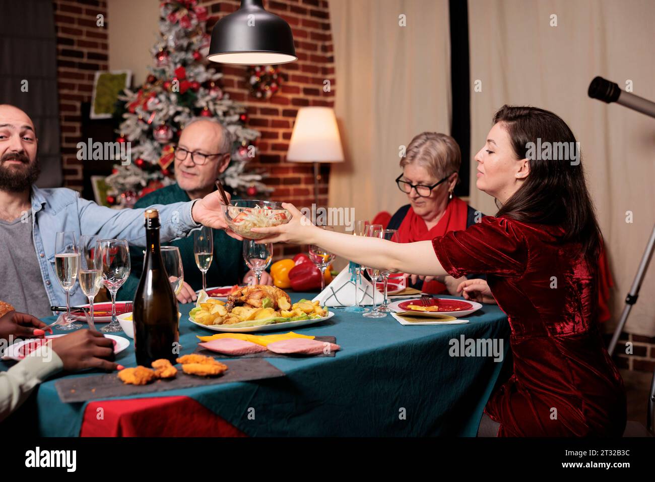 Family eating festive meal at dinner, celebrating Christmas eve ...