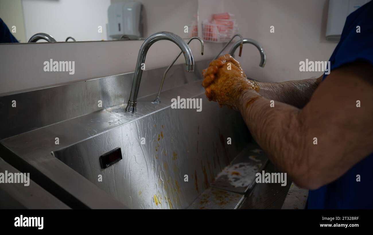 Before the operation, the doctor sterilizes his hands. The doctor ...