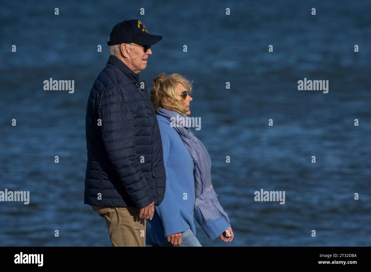 President Joe Biden and first lady Jill Biden walk along the beach in ...