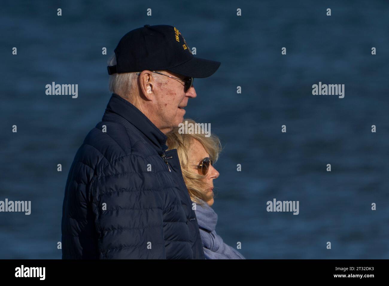 President Joe Biden and first lady Jill Biden walk along the beach in ...