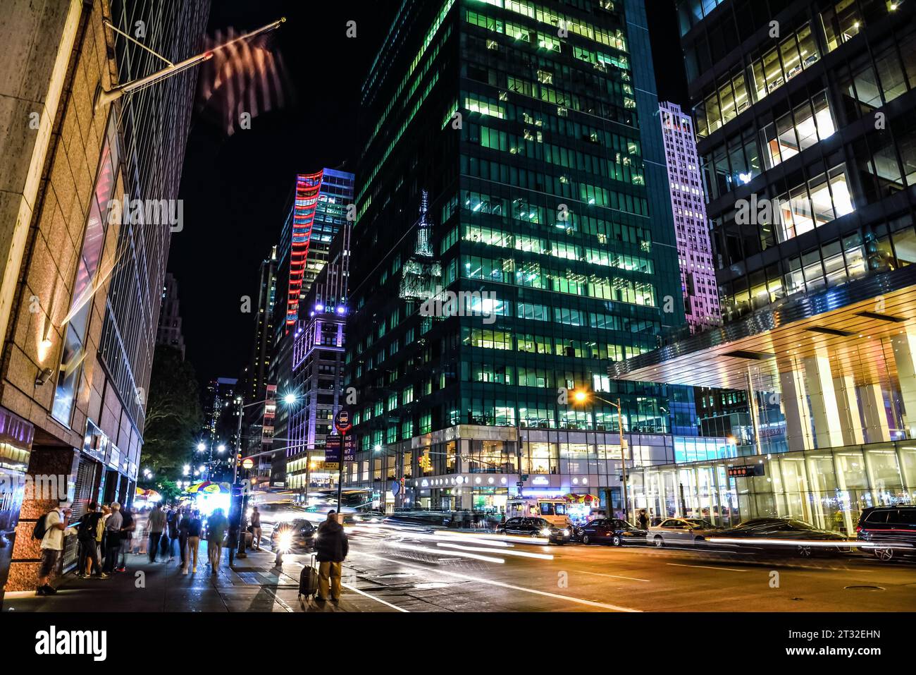 Night Time on the 6th Avenue, with the Empire State Building Reflected ...