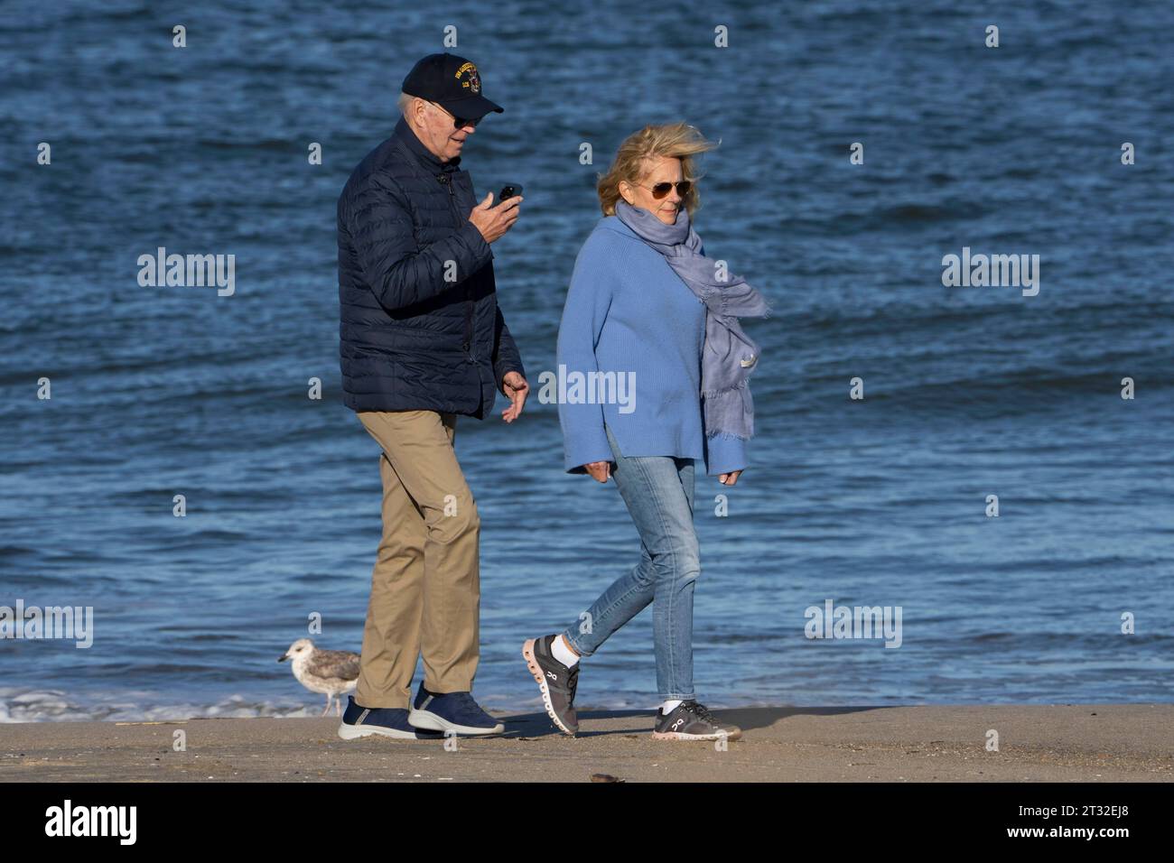 President Joe Biden and first lady Jill Biden walk along the beach in ...