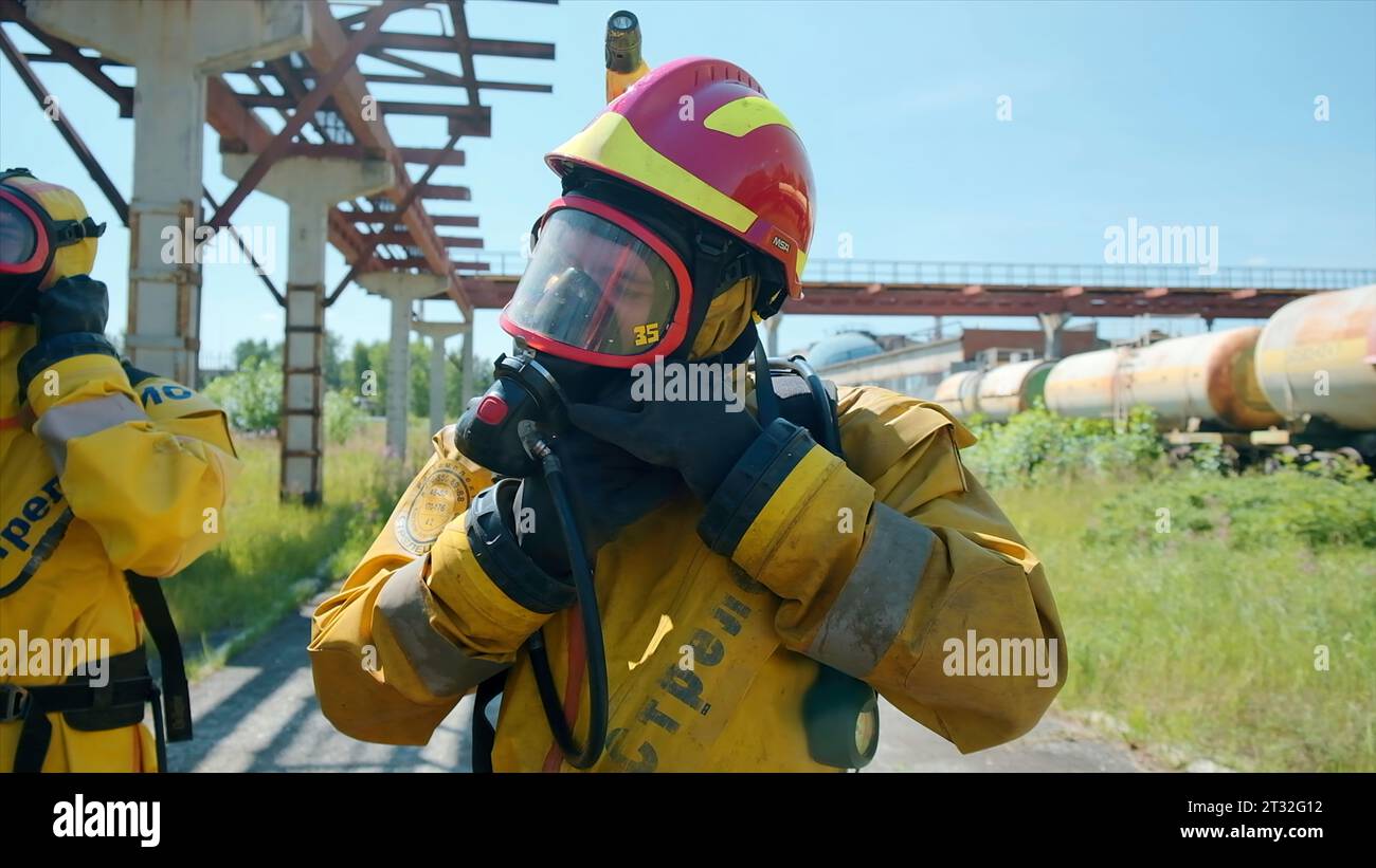 Fire safety exercises. Clip. Men in special uniforms and gas masks ...