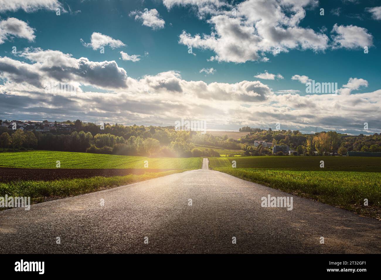 straight road made of asphalt with a view into the distance under a ...