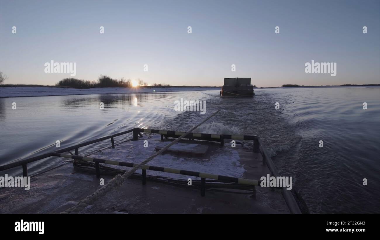 View of floating barge with cable on river. Clip. Floating barge behind ...