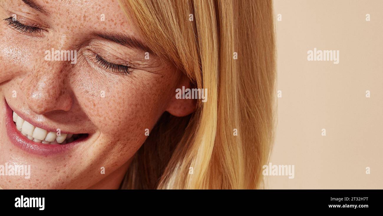 Close-up high detailed cropped shot of a smiling blonde woman with ...