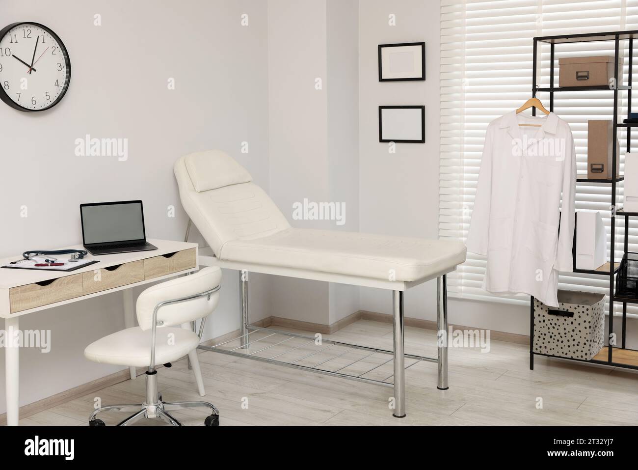Modern medical office with doctor's workplace and examination table in ...