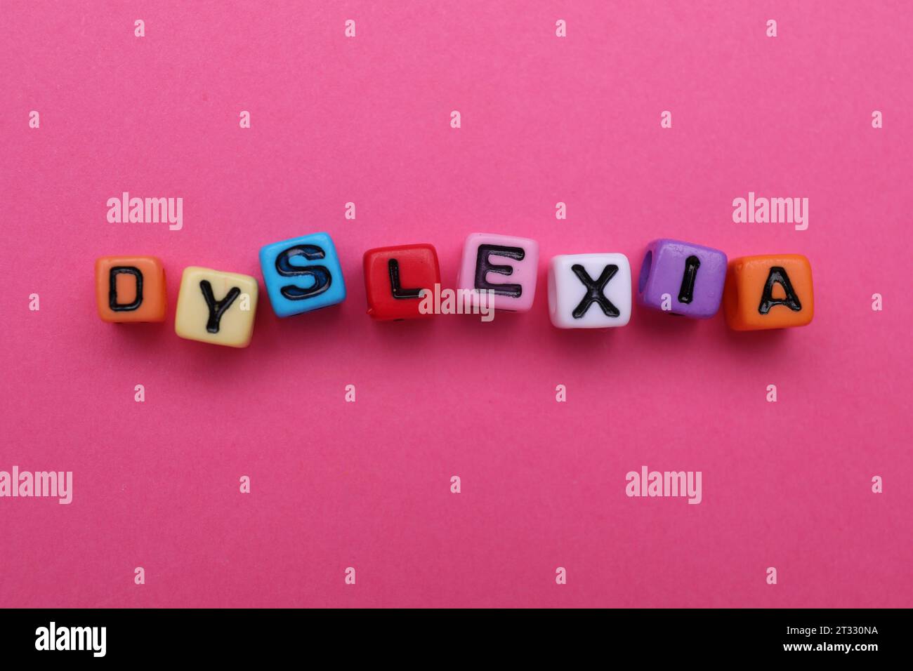 Colorful beads with word Dyslexia on pink background, flat lay Stock ...