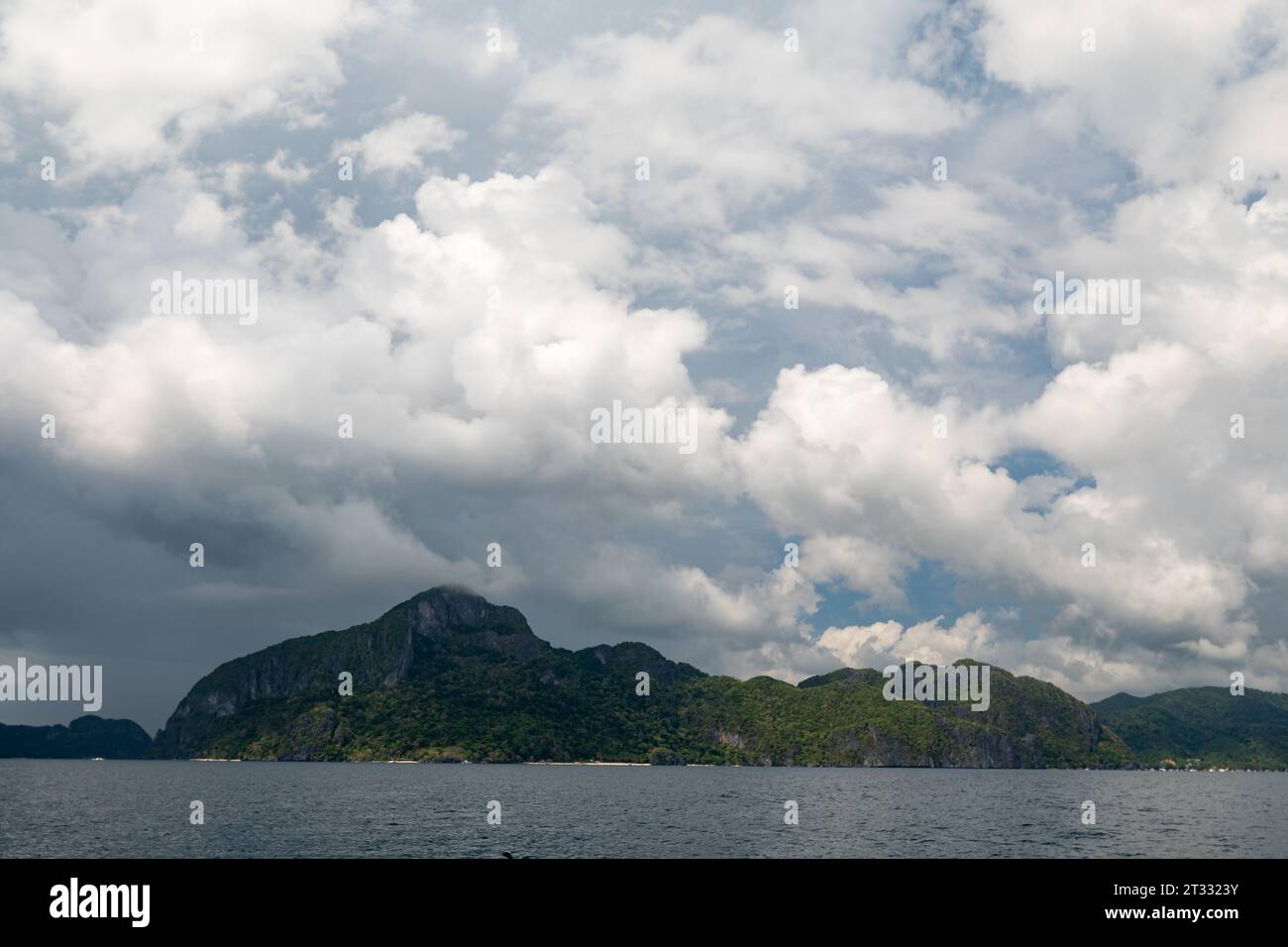 Scenic limestone karst formations rising out of tropical sea with ...