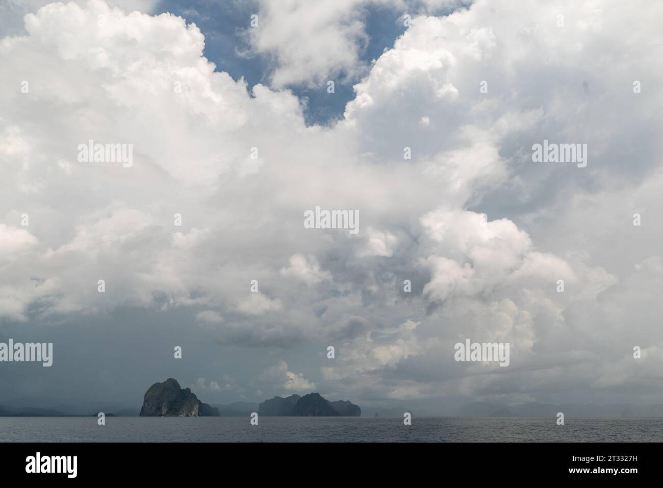 Rain storm moves over scenic limestone karst formations rising out of ...