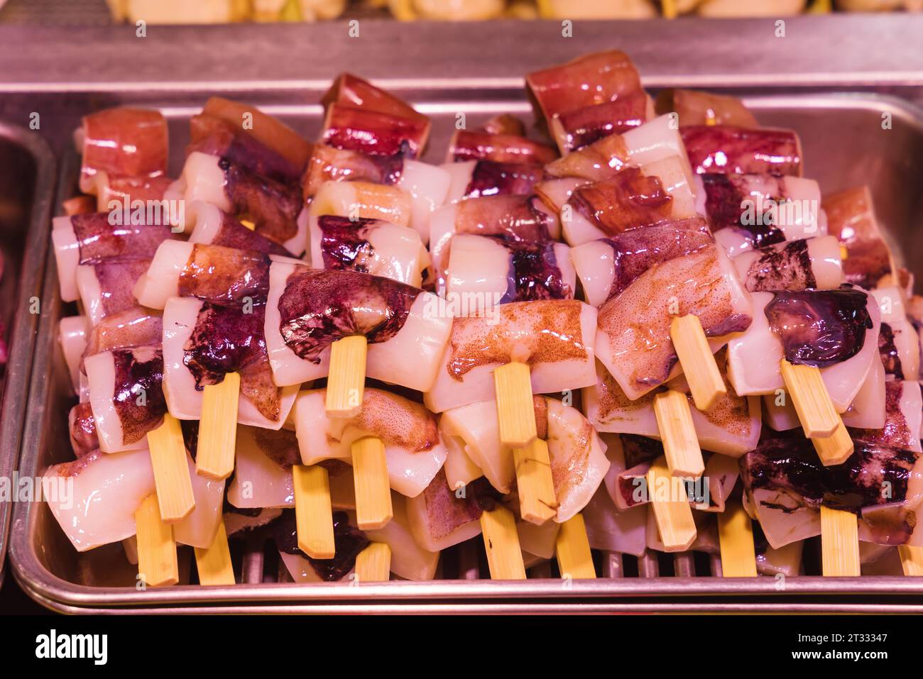 Display of skewers of raw squid at the famous Nishiki fish market in ...